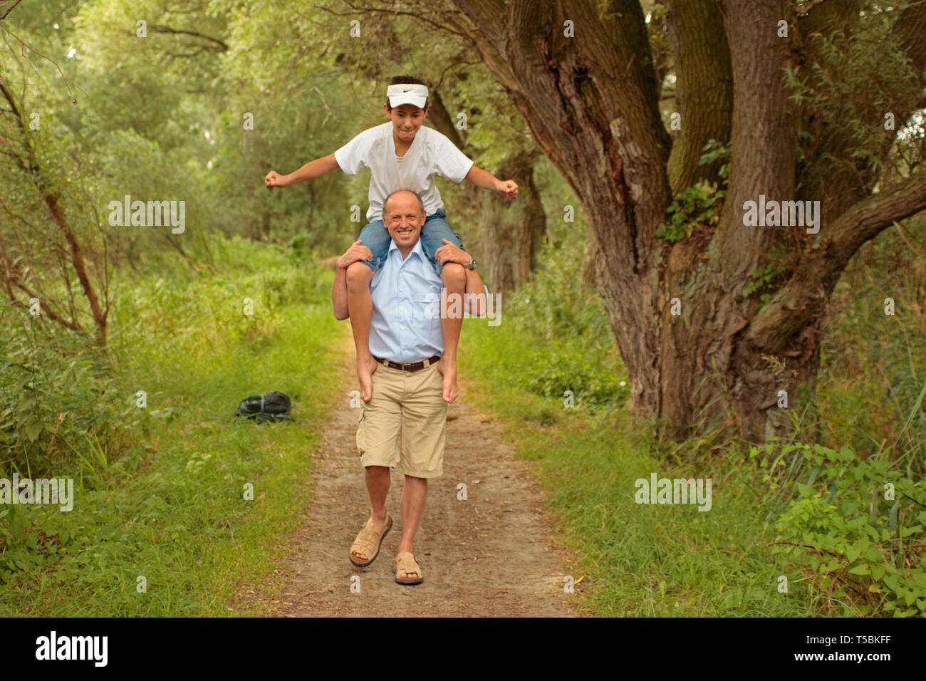 man carrying boy on his shoulders Stock Photo - Alamy