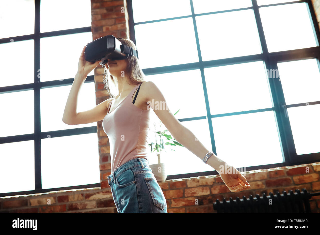 Woman wearing VR headset at home Stock Photo - Alamy