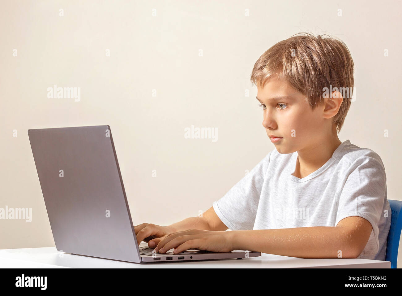 Boy profile study typing hi-res stock photography and images - Alamy