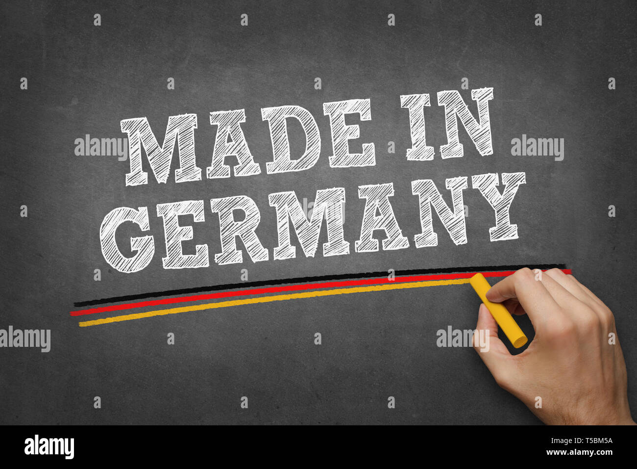 hand writing MADE IN GERMANY on chalkboard - underlining with colours ...