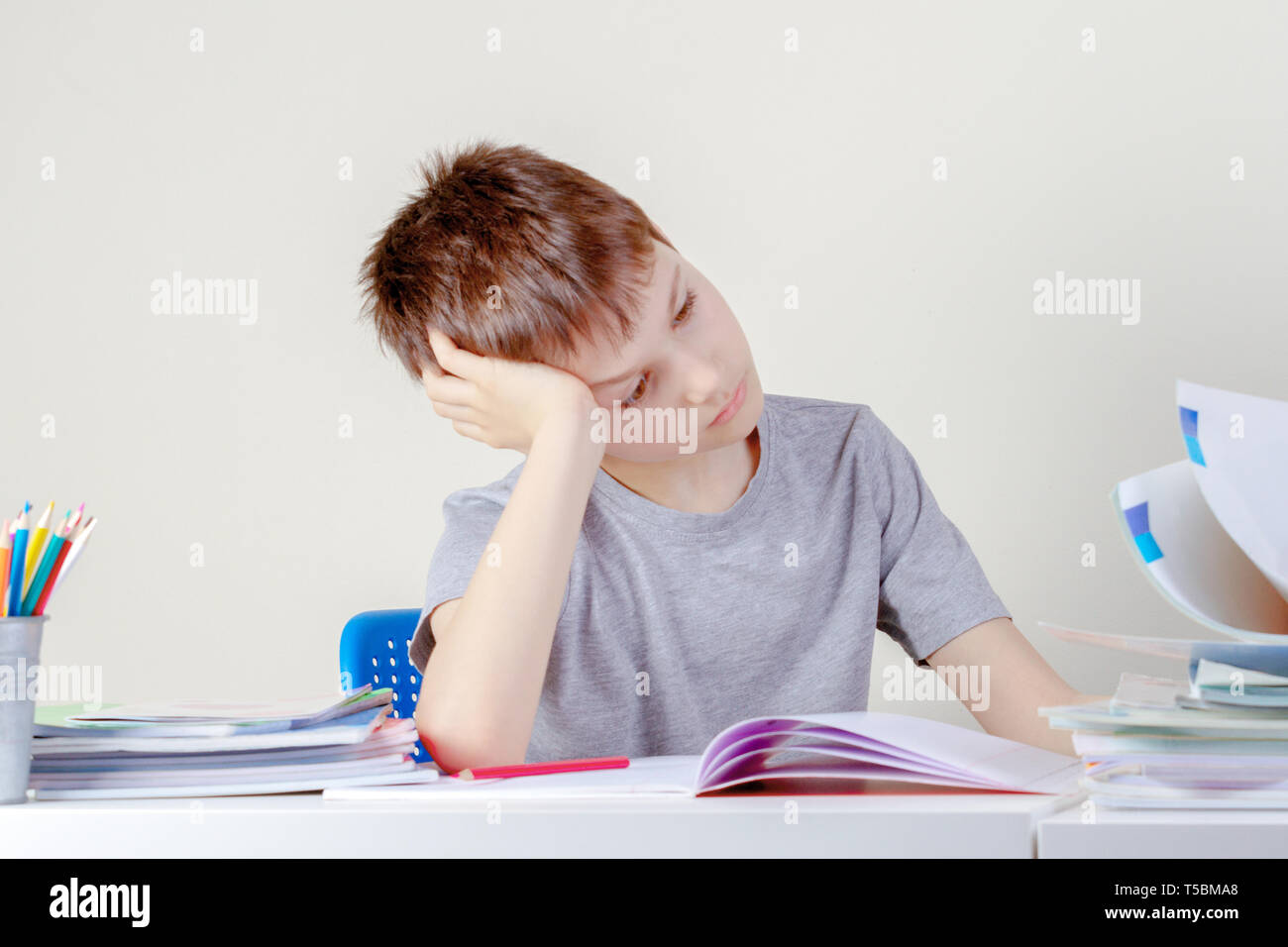Frustrated boy with stack of books hi-res stock photography and images ...