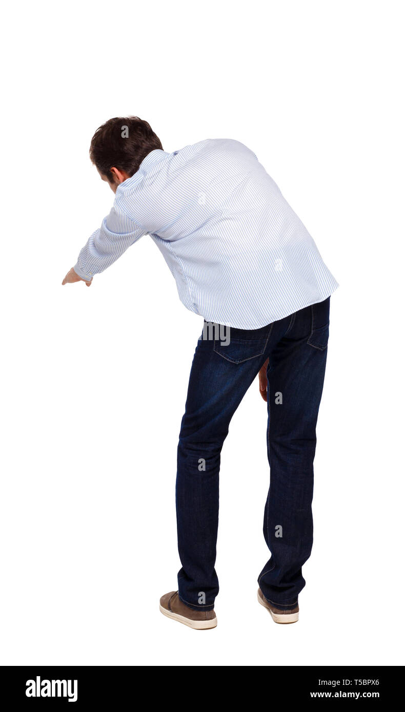 Back view of a man in jeans points his hand upwards. Rear view people ...