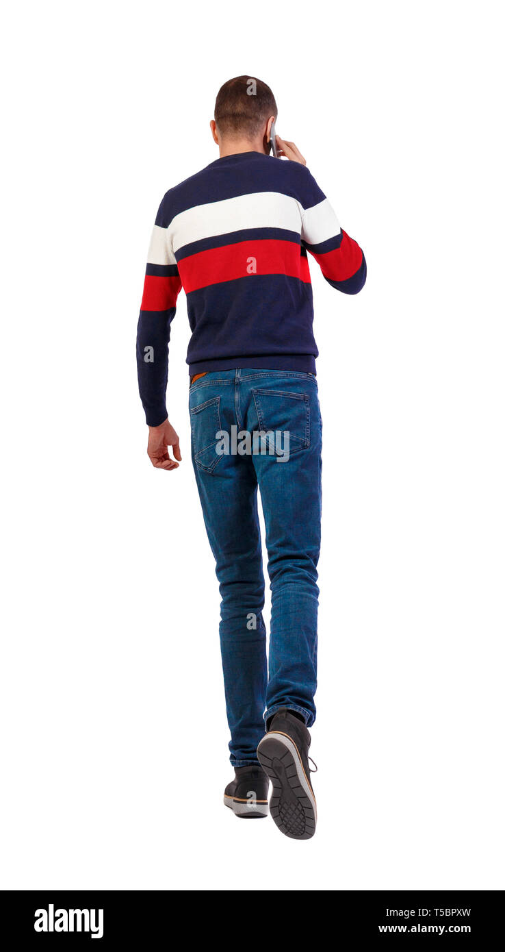 Back view of man walking with a mobile phone. backside view of person ...