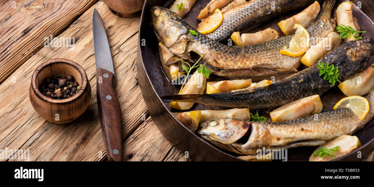 Baked fish in apples, lemon and spices.Delicious fish Stock Photo - Alamy