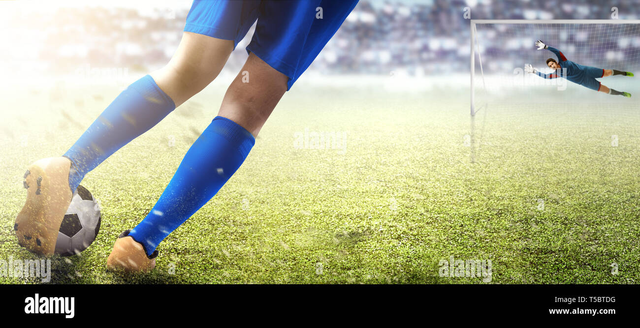 Football player man kicking the ball in the penalty box and asian ...
