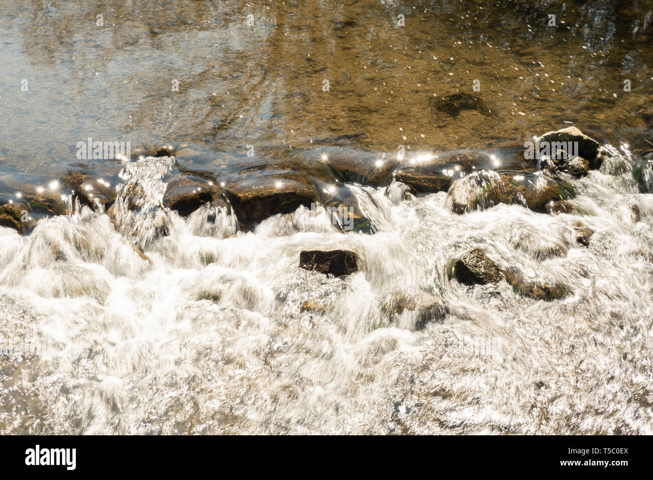 Water flowing from a small river Stock Photo - Alamy