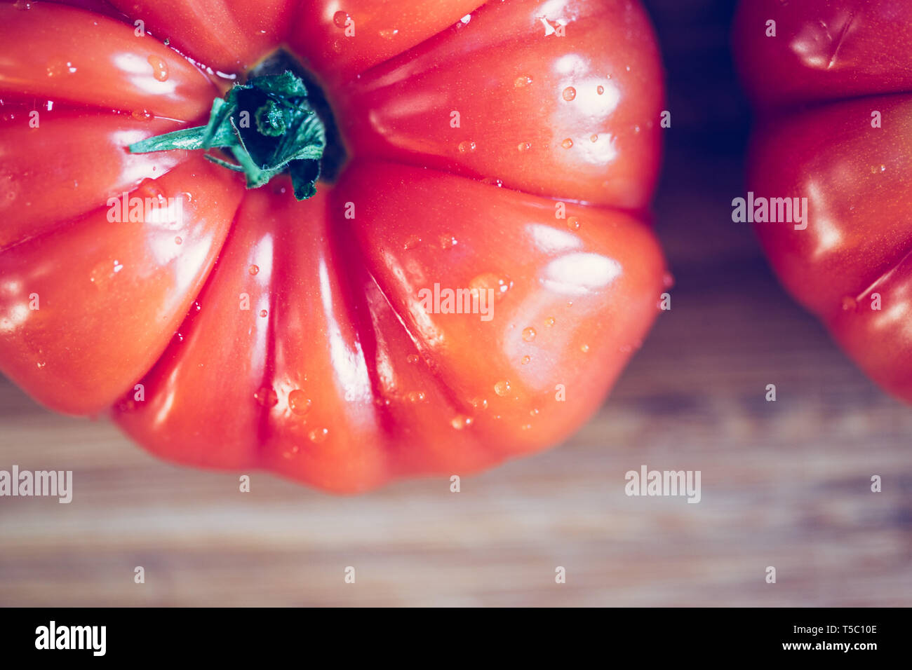 Close up picture of oxheart tomatoes on a bamboo wood plate Stock Photo ...