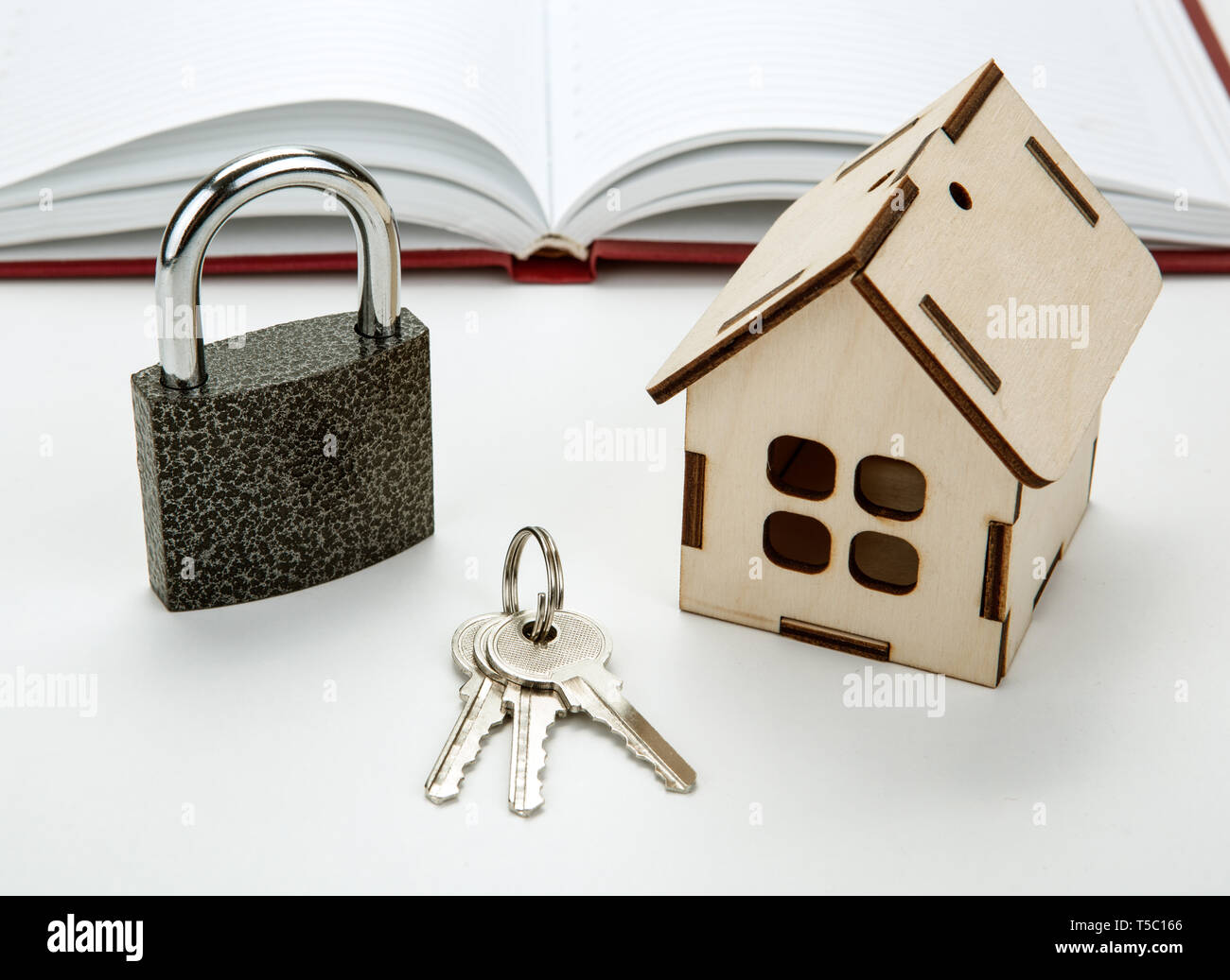 wooden miniature house with keys and padlock Stock Photo - Alamy