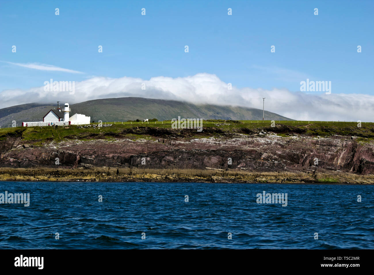 Beautiful,white lighthouse located on the shore of Dingle Bay in County ...