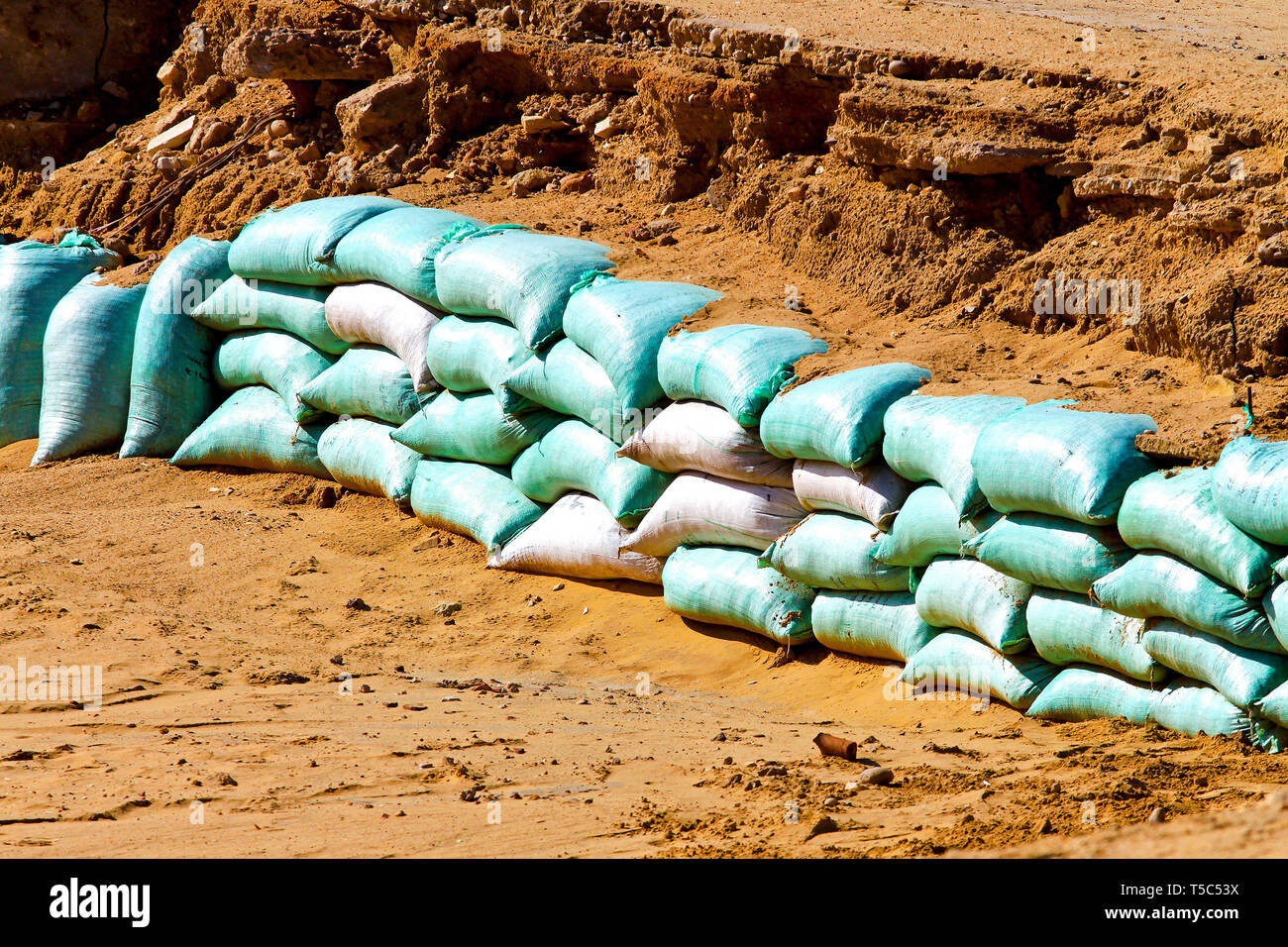 Sand bags barrier for water flood protection Stock Photo - Alamy