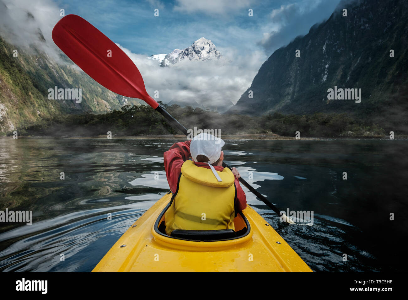 Boy kayaking on mountain lake hi-res stock photography and images - Alamy