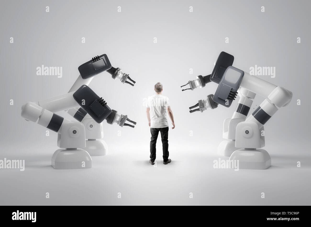 Robotic machines and humans.A man standing next to robotic ...