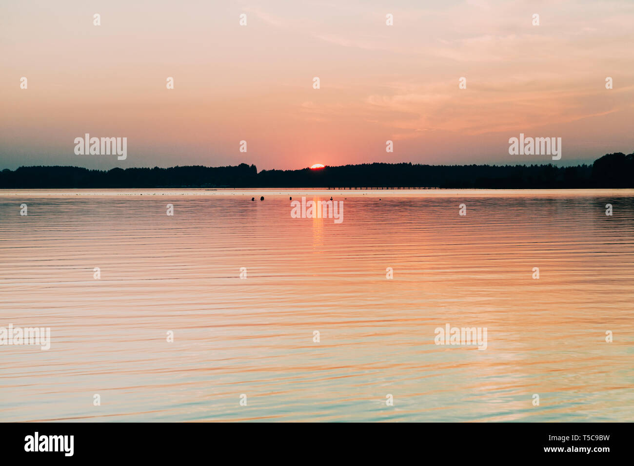 Sun hiding behind the horizon in the lake of chiemsee Stock Photo - Alamy