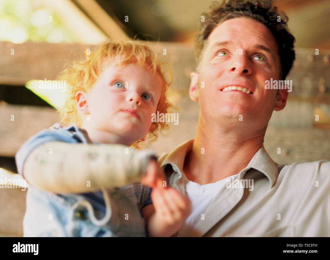 A father and his child are watching intently Stock Photo - Alamy
