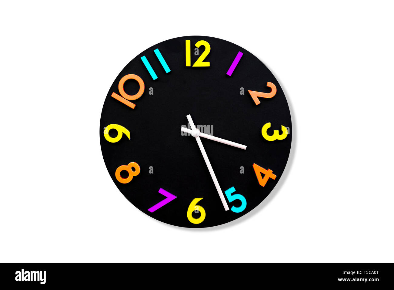 A black wall clock isolated on a white background. Hours in different ...