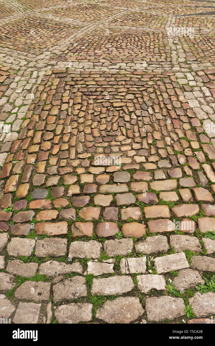 Old square paved with large cobblestones and grass between them Stock ...