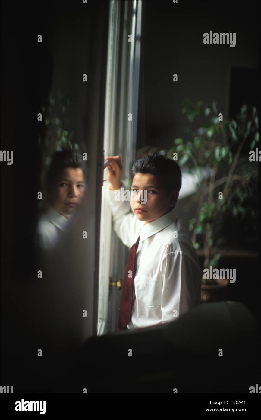 A smartly dressed boy looks sideways at the camera Stock Photo - Alamy