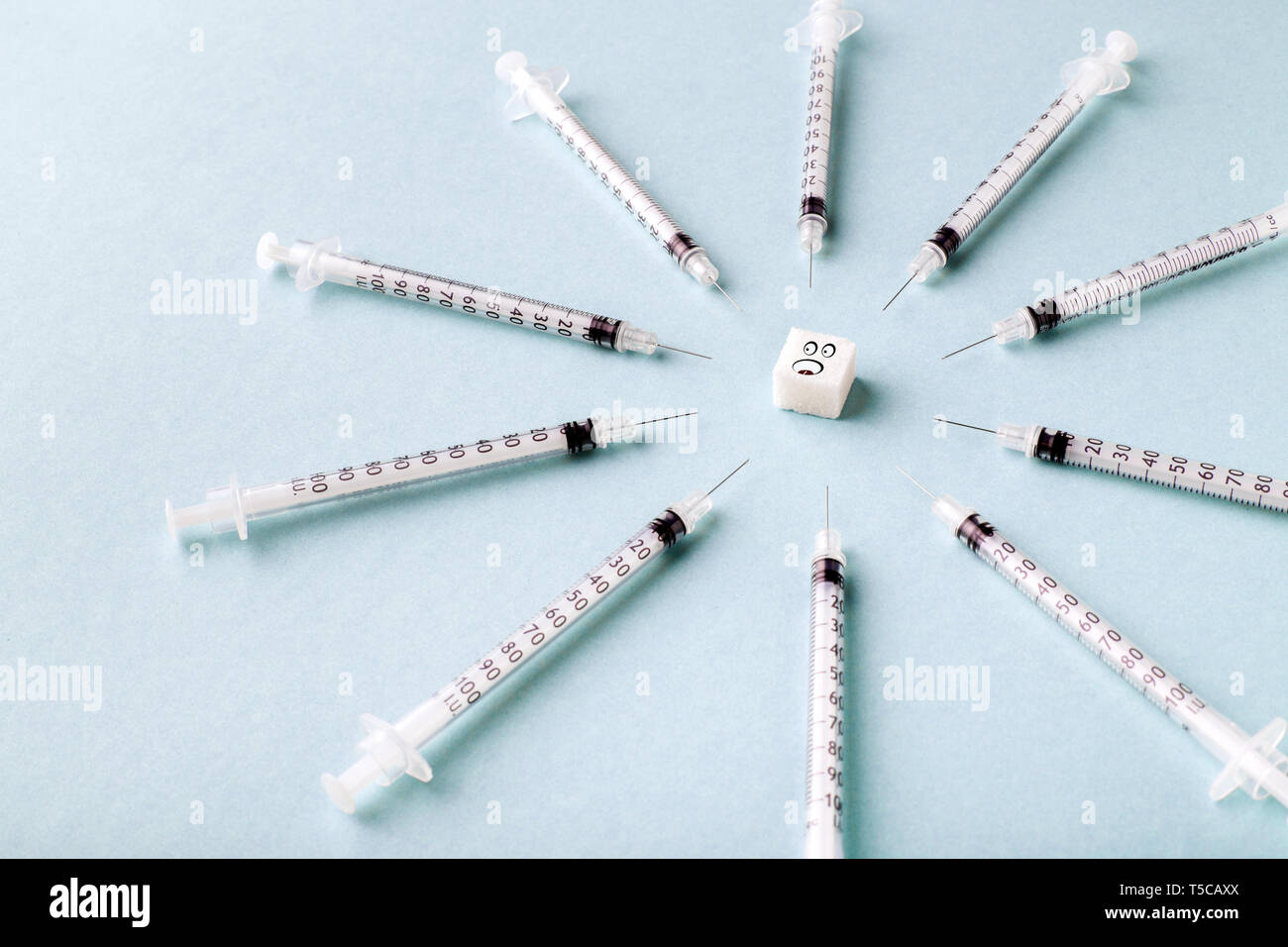 insulin syringes stuck in a scared sugar cube, diabetes treatment ...