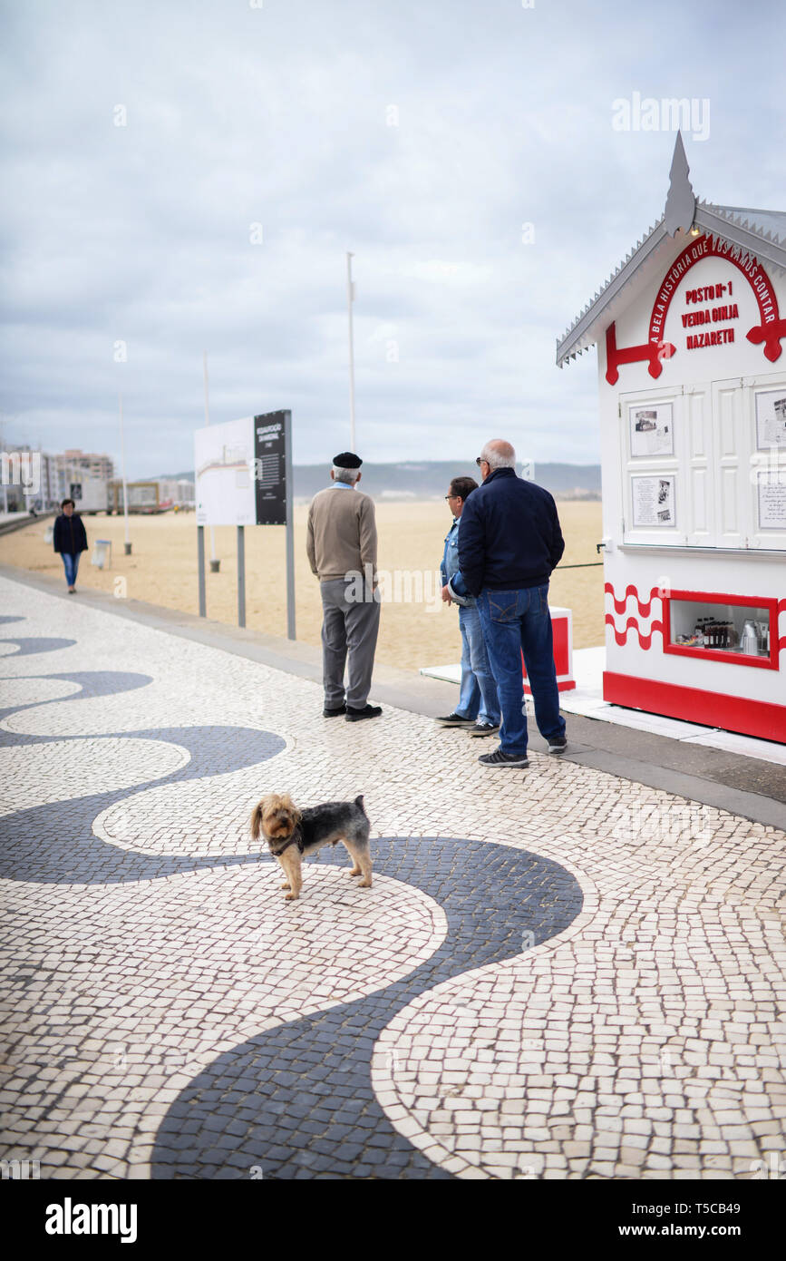 People on the beach walk of Nazare, Portugal Stock Photo - Alamy