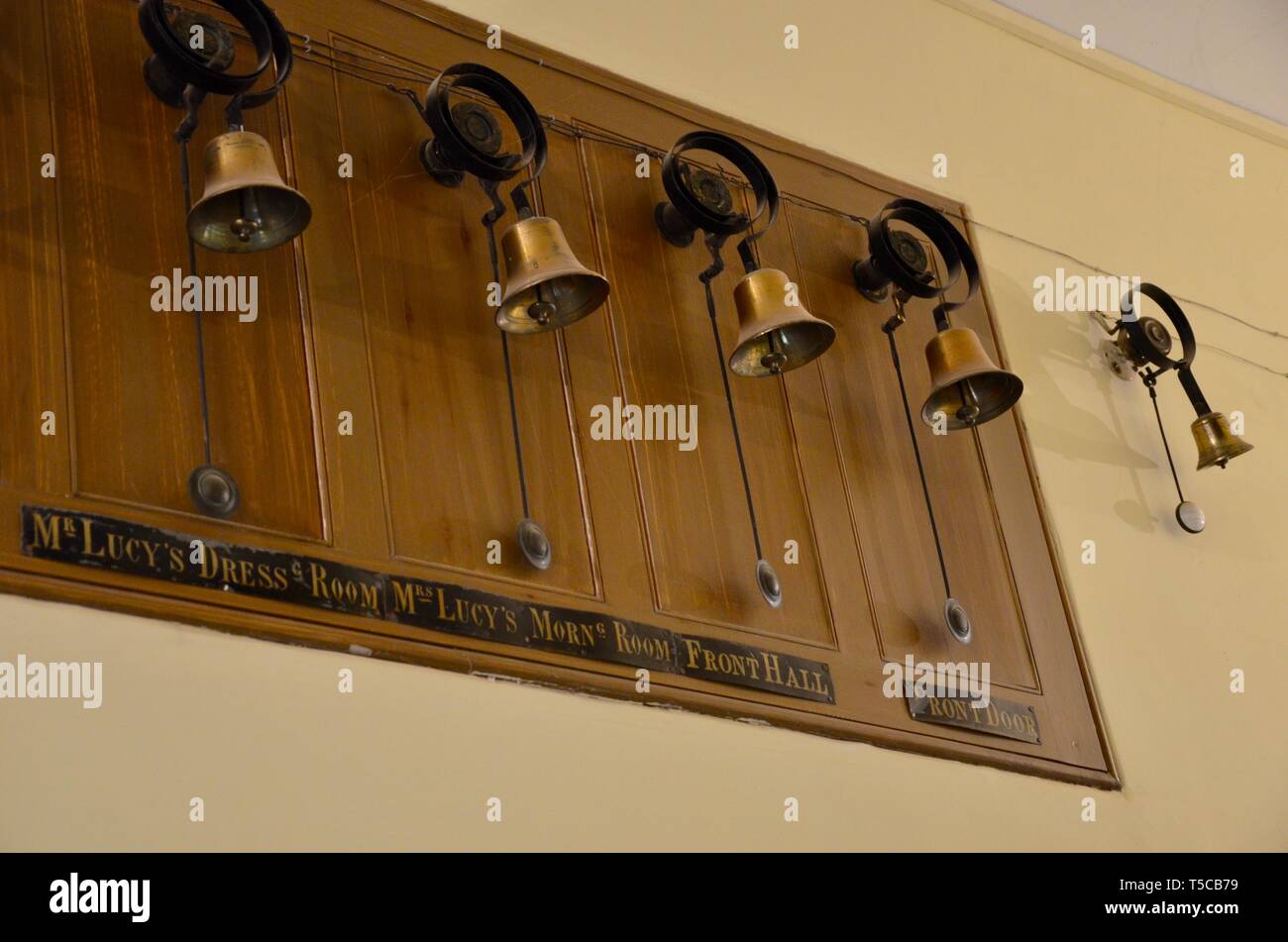 Servants' bells on wall of house in Charlecote Park, Warwickshire ...