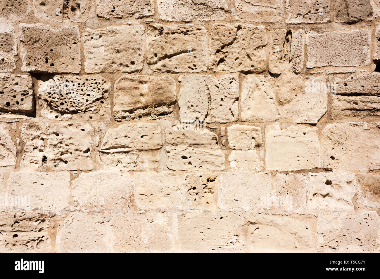 Old, brown, sandy wall of a stone house in the open air. Seamless ...