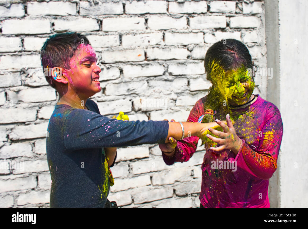 Two Indian kids Playing Holi In A Holi Color Festival Stock Photo - Alamy