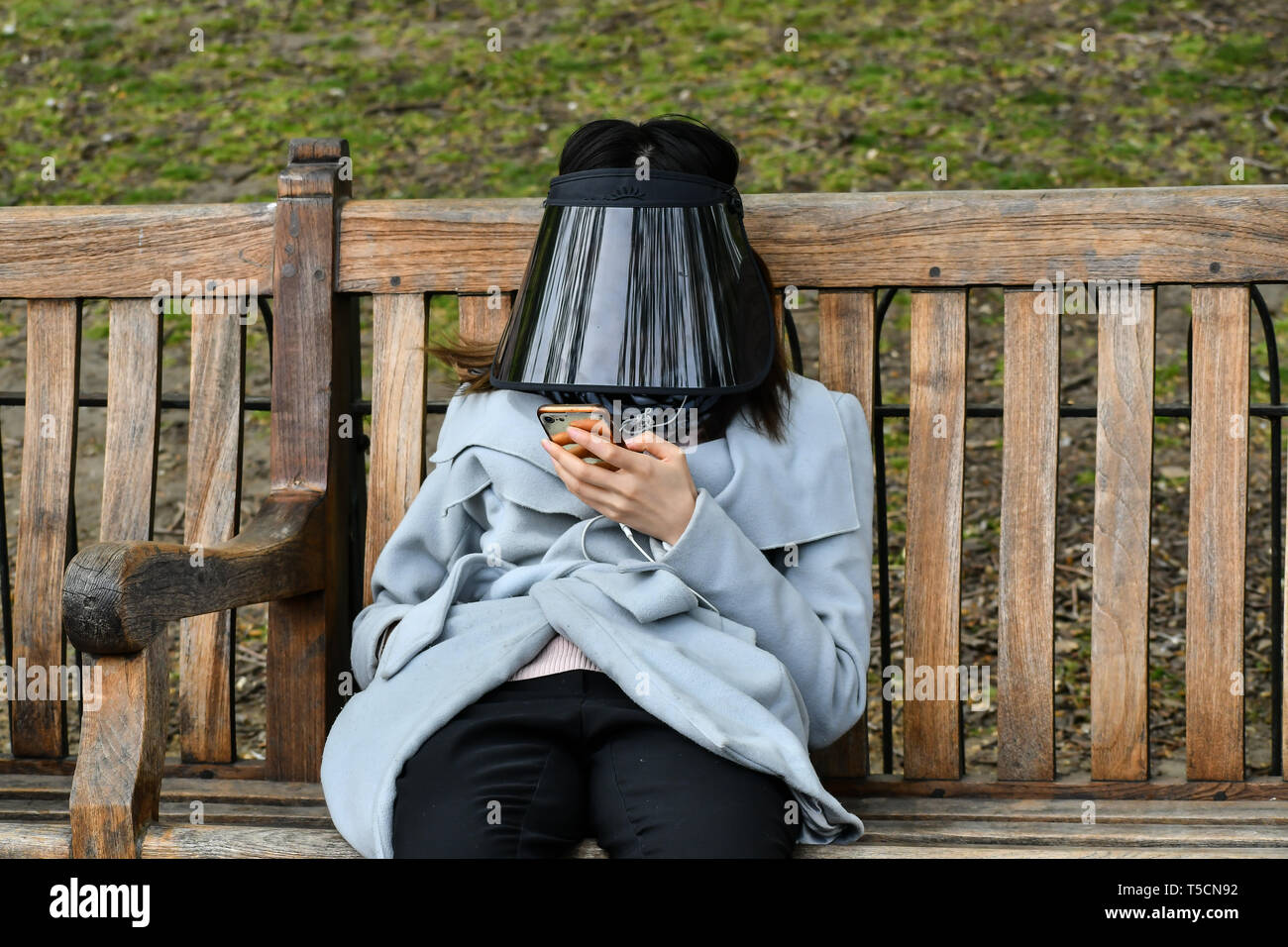 London, UK. 23rd Apr, 2019. A Asian girl wearing a fashion face shield ...