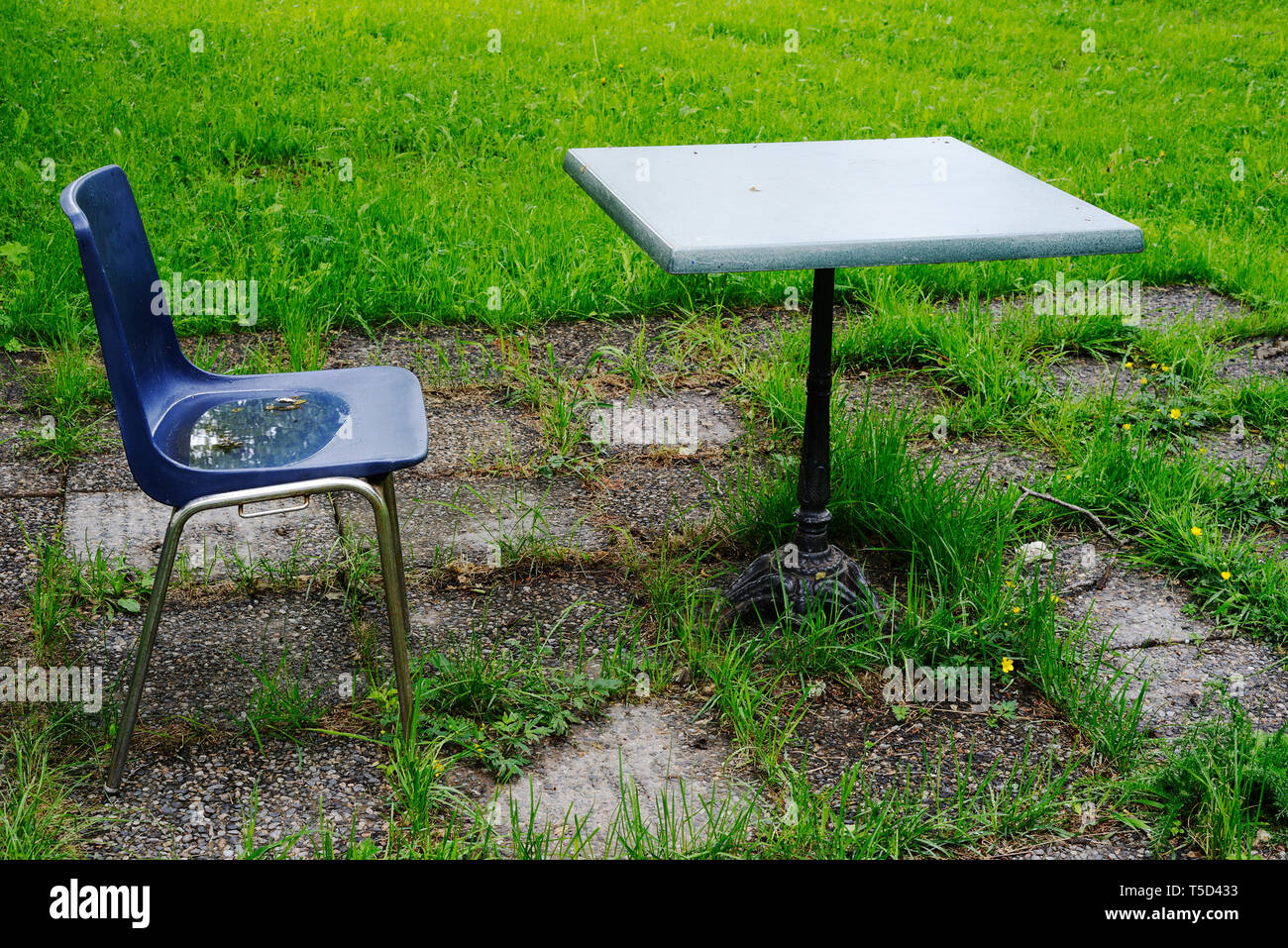 plastic chair and table on the lawn after the rain Stock Photo - Alamy