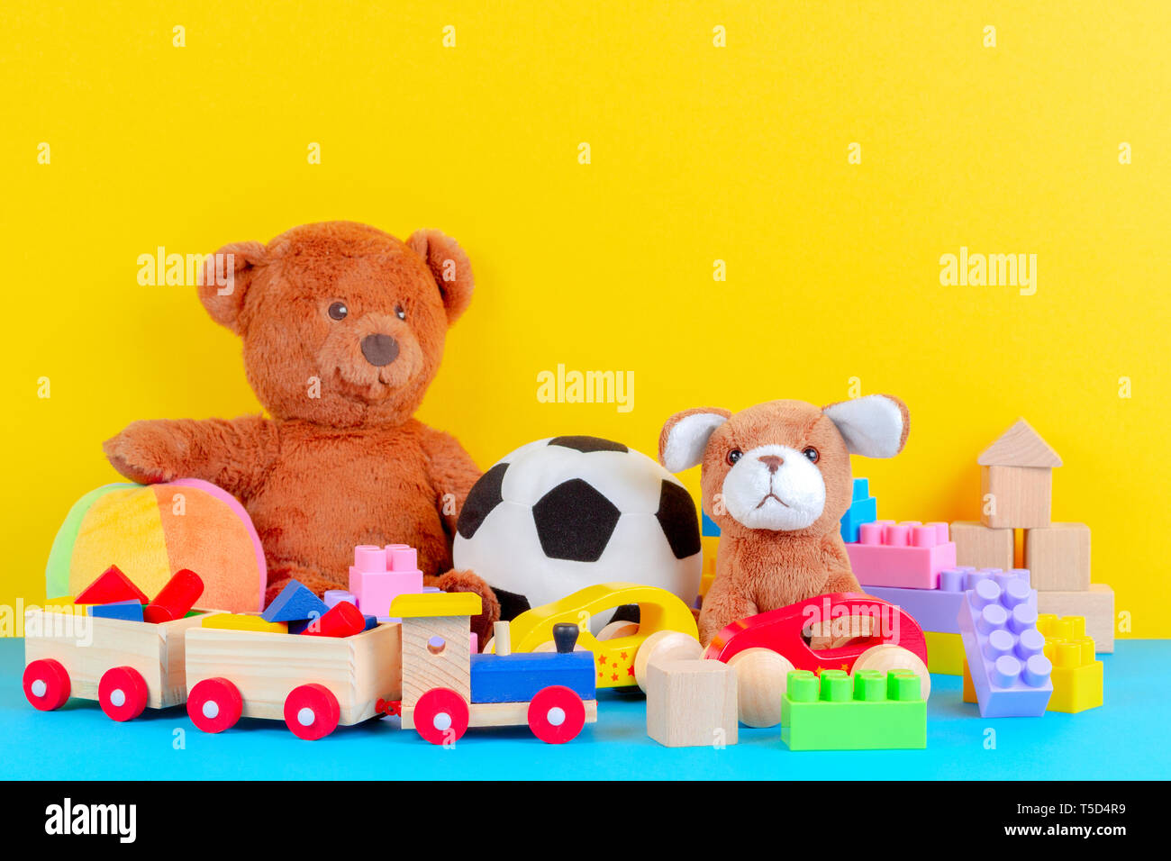 Baby kid toys collection on blue and yellow background Stock Photo - Alamy