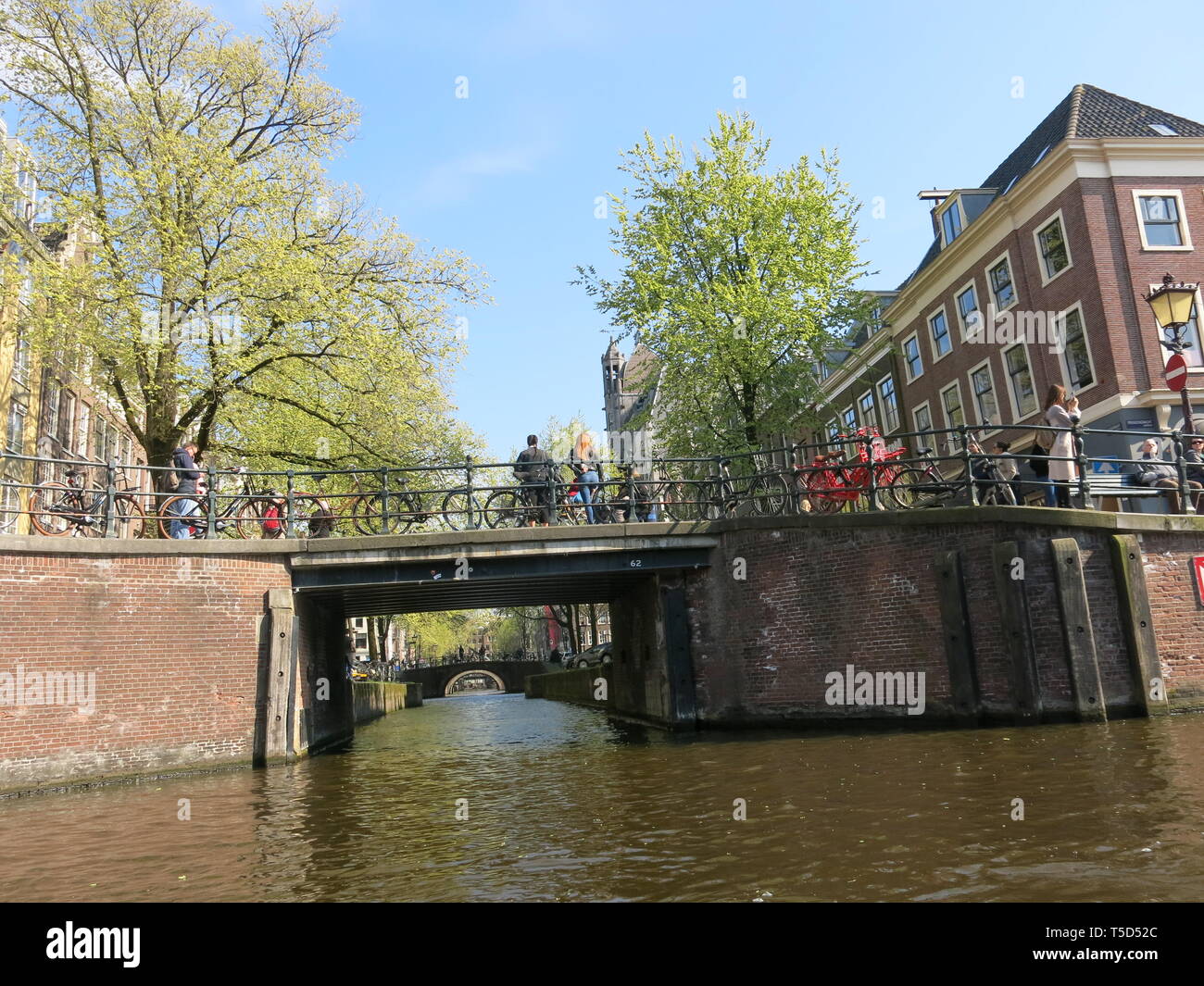 View under a canal bridge in Amsterdam with a series of further canal ...