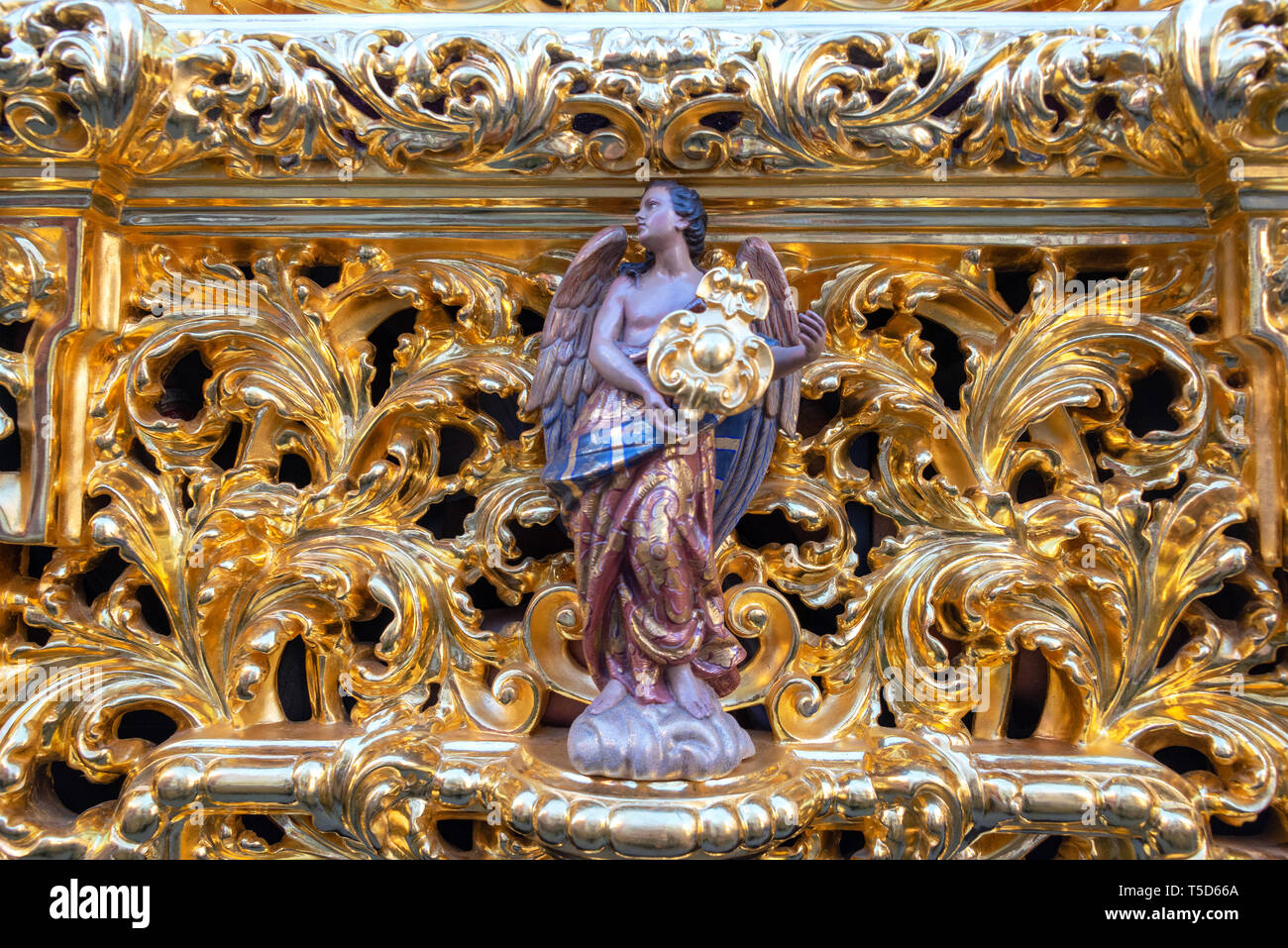 Ornate angel on a golden Holy Week float in Seville, Spain Stock Photo ...