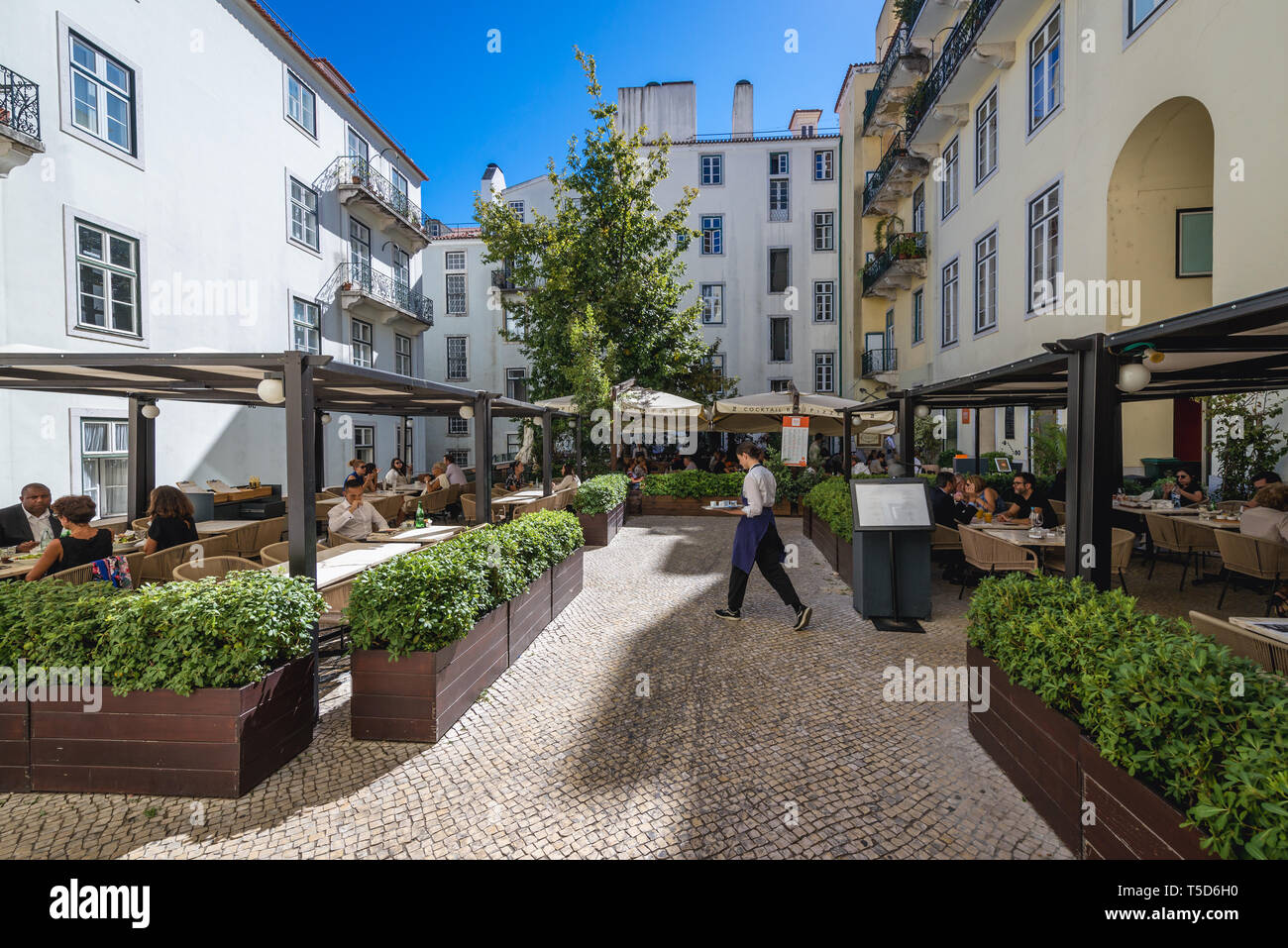 Restaurants in a courtyard among houses in Chiado area of Lisbon ...