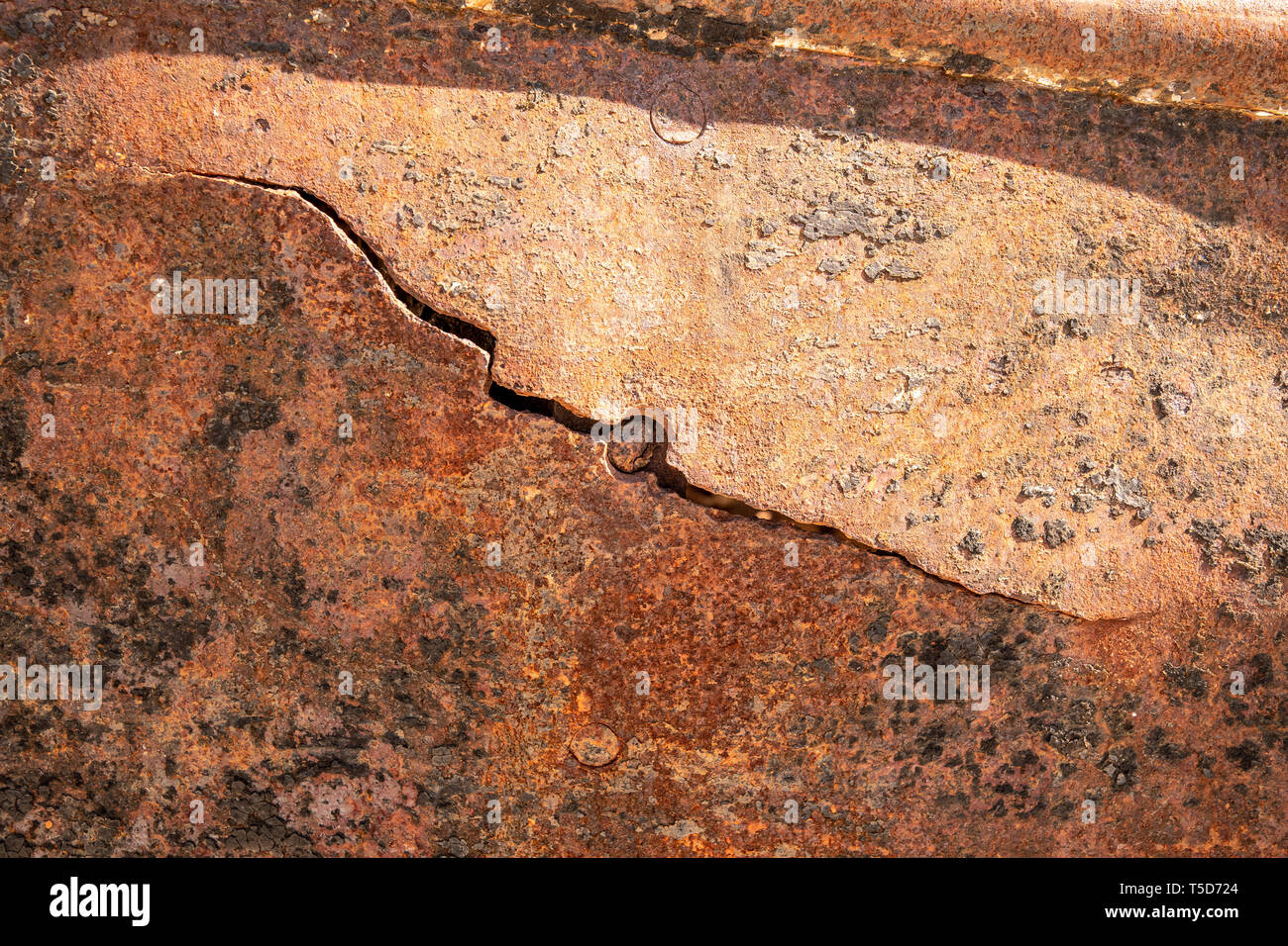 rusty iron plate with a crack and a nail as background Stock Photo - Alamy