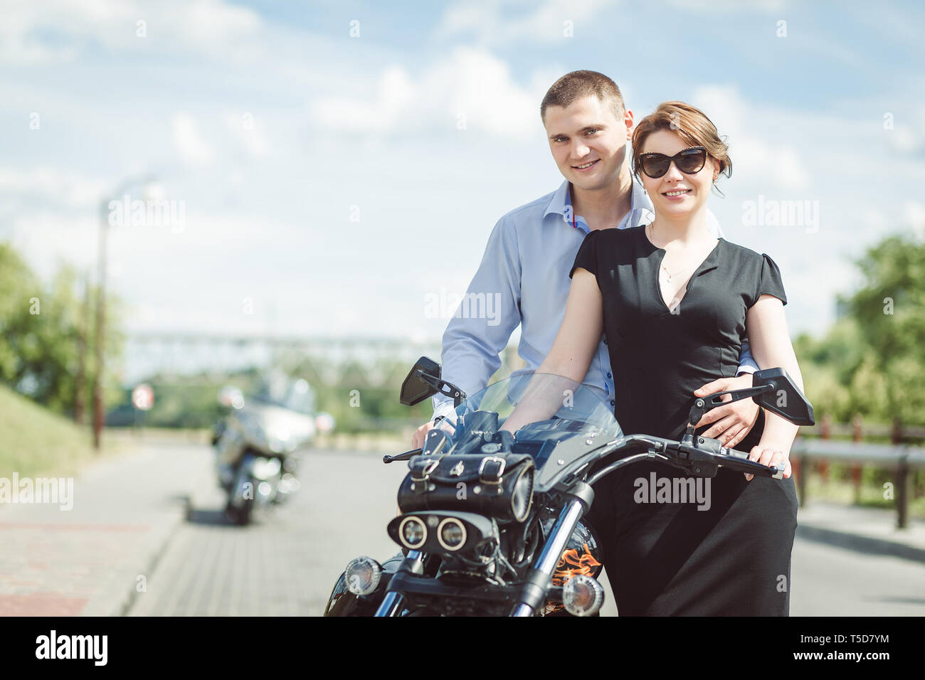 Portrait of two beautiful young lovers posing with motorcycle Stock ...