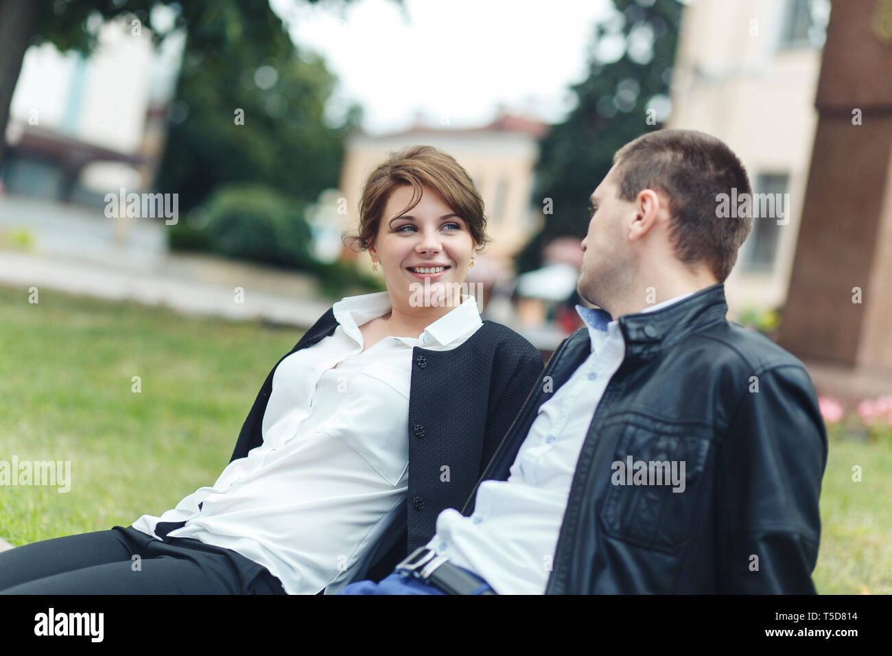Portrait of two beautiful young lovers in the park Stock Photo - Alamy