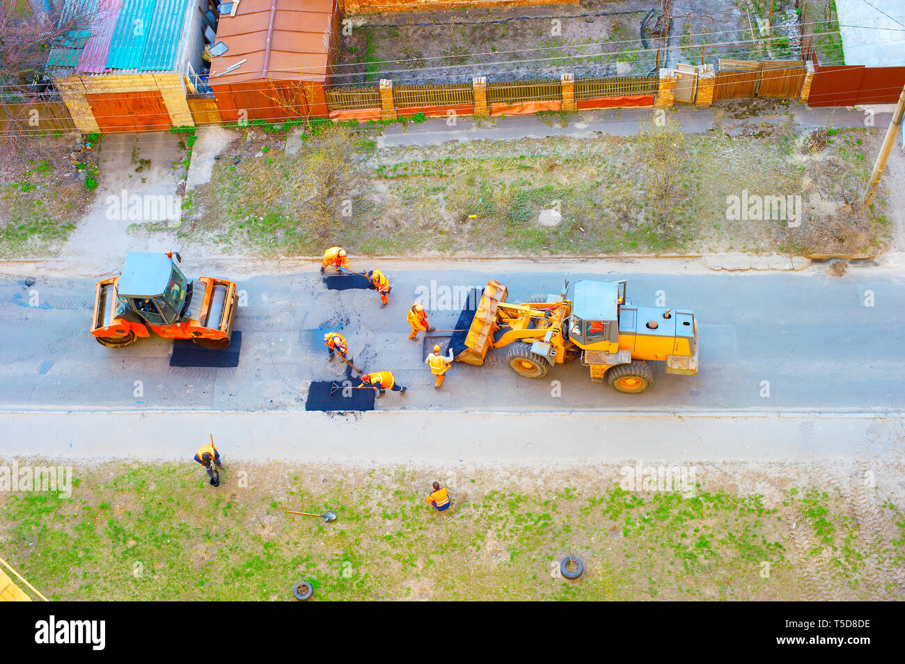 Workers, excavator, roller compactor repair road, top view, Kiev ...