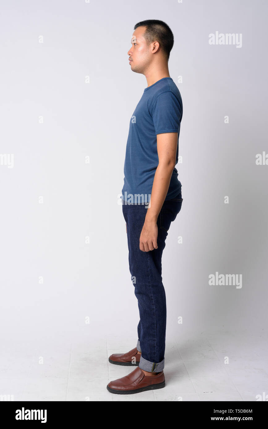 Full body shot profile view of young Asian man Stock Photo - Alamy