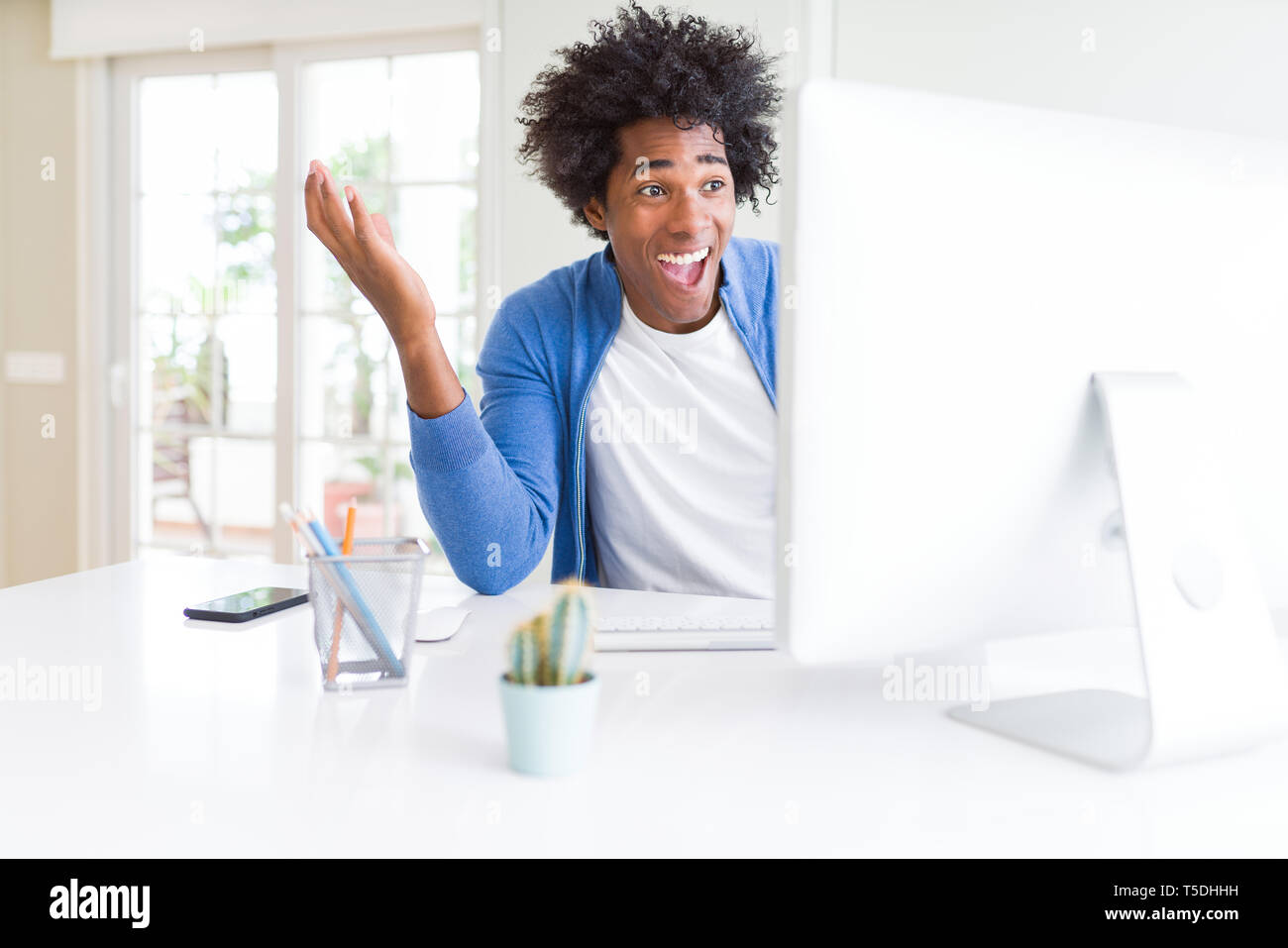 African American man working using computer very happy and excited ...