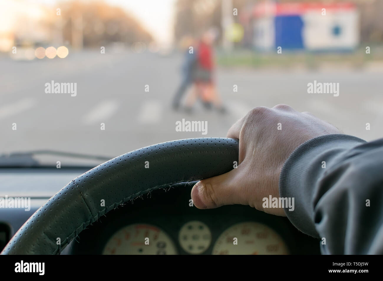 view from the car, the man's hand on the steering wheel of the car ...