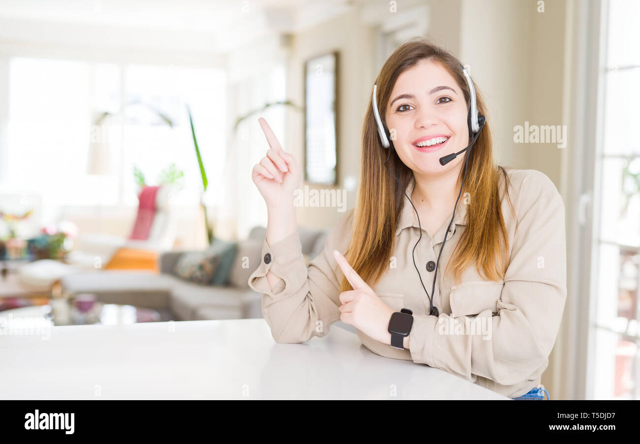 Beautiful young operator woman wearing headset at the office smiling ...