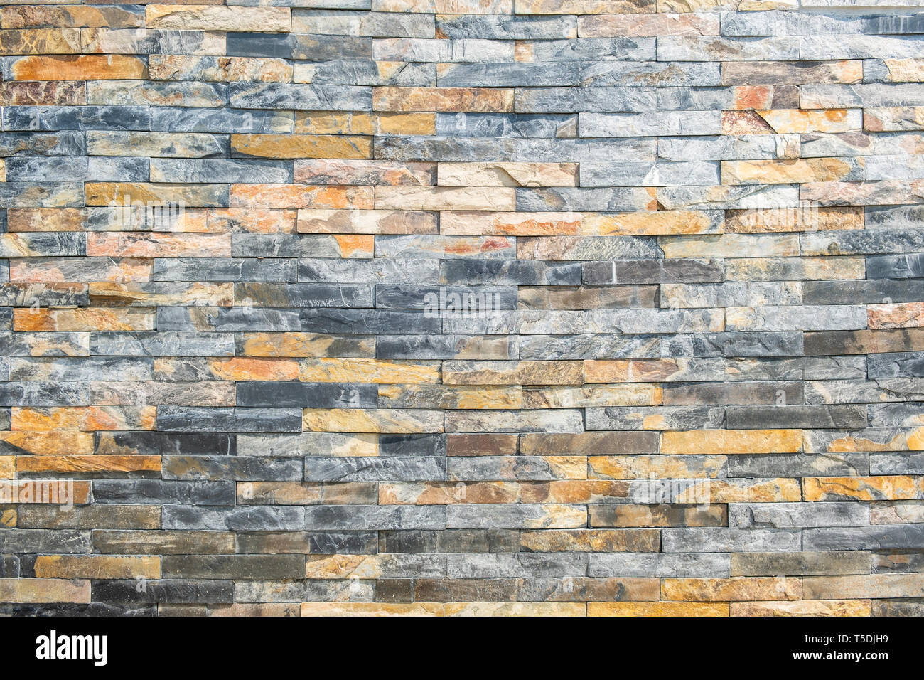 brick wall , texture of milti colored stone blocks , background Stock ...