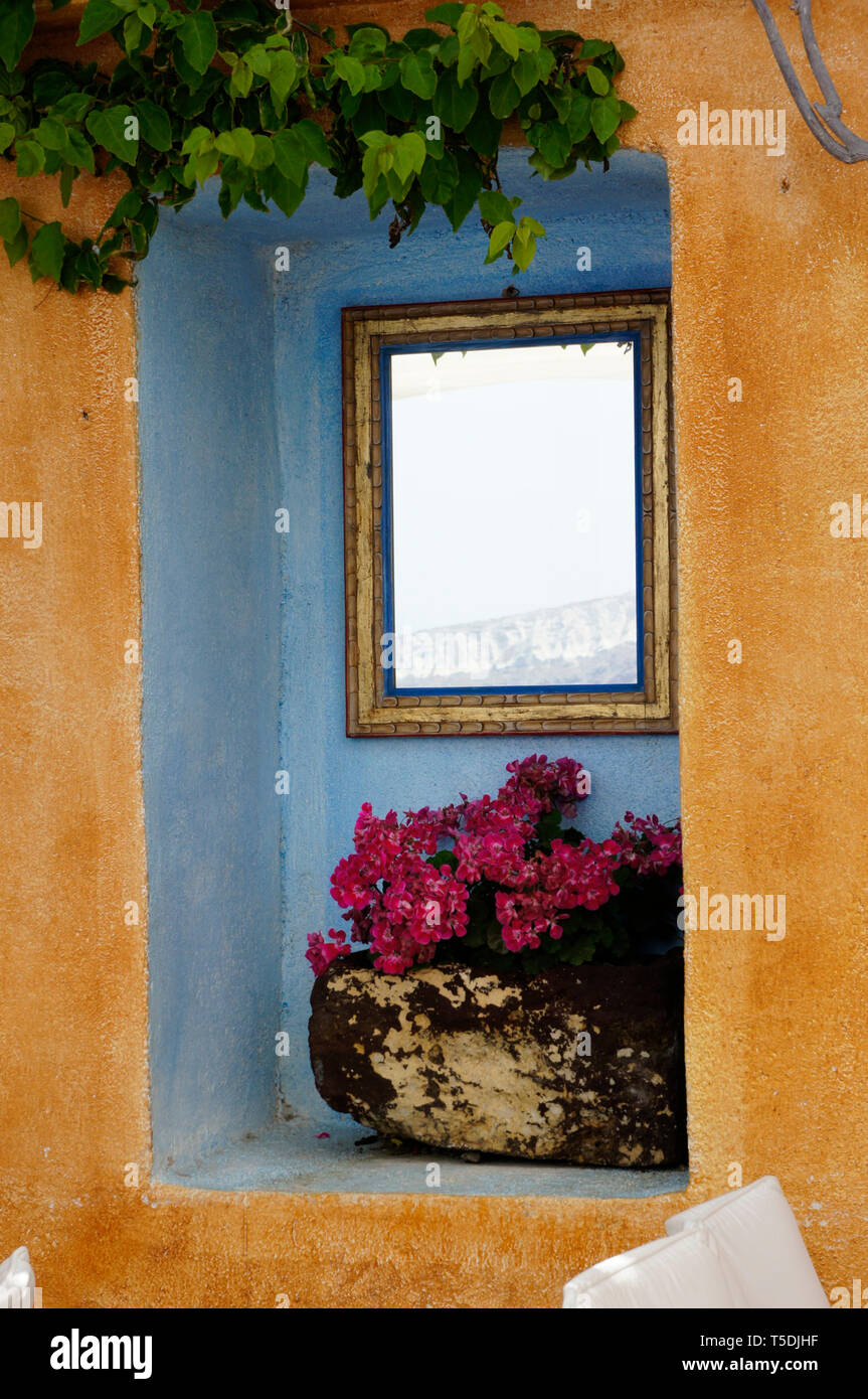 Mirror on window with blue and terracotta surround and red ...