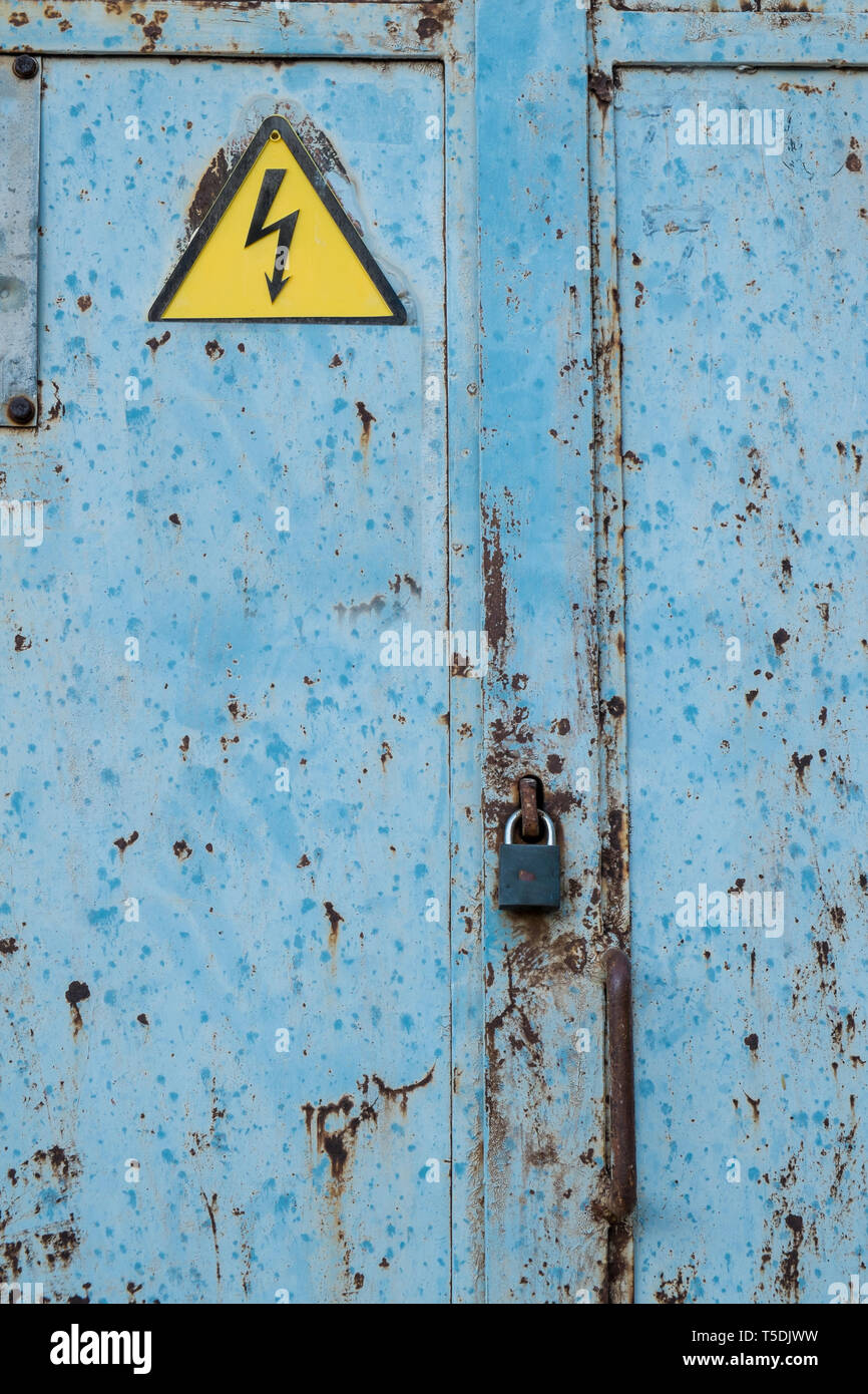 Old door with shock hazard sign Stock Photo - Alamy