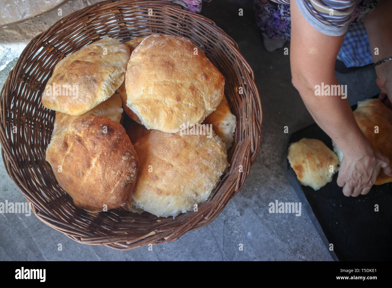 traditional village breads taken from tray to basket Stock Photo - Alamy
