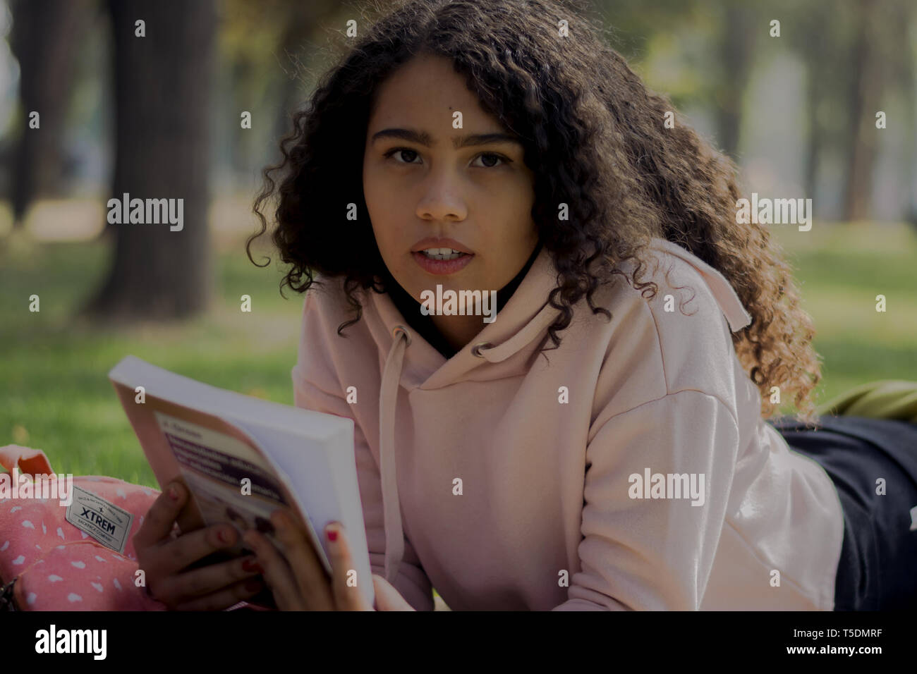 Girl just reading in the park Stock Photo - Alamy
