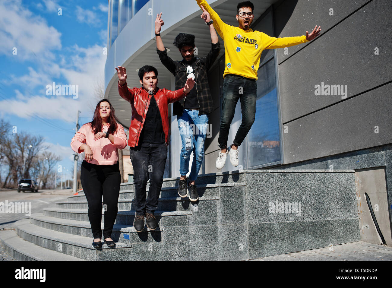 Group of asian people friends stand on stairs outdoor against modern ...