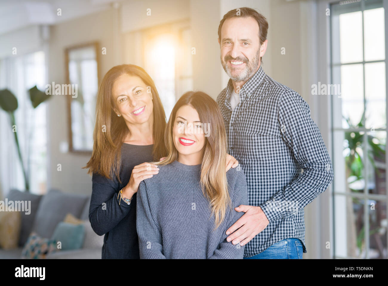 Beautiful family together. Mother, father and daughter smiling and ...