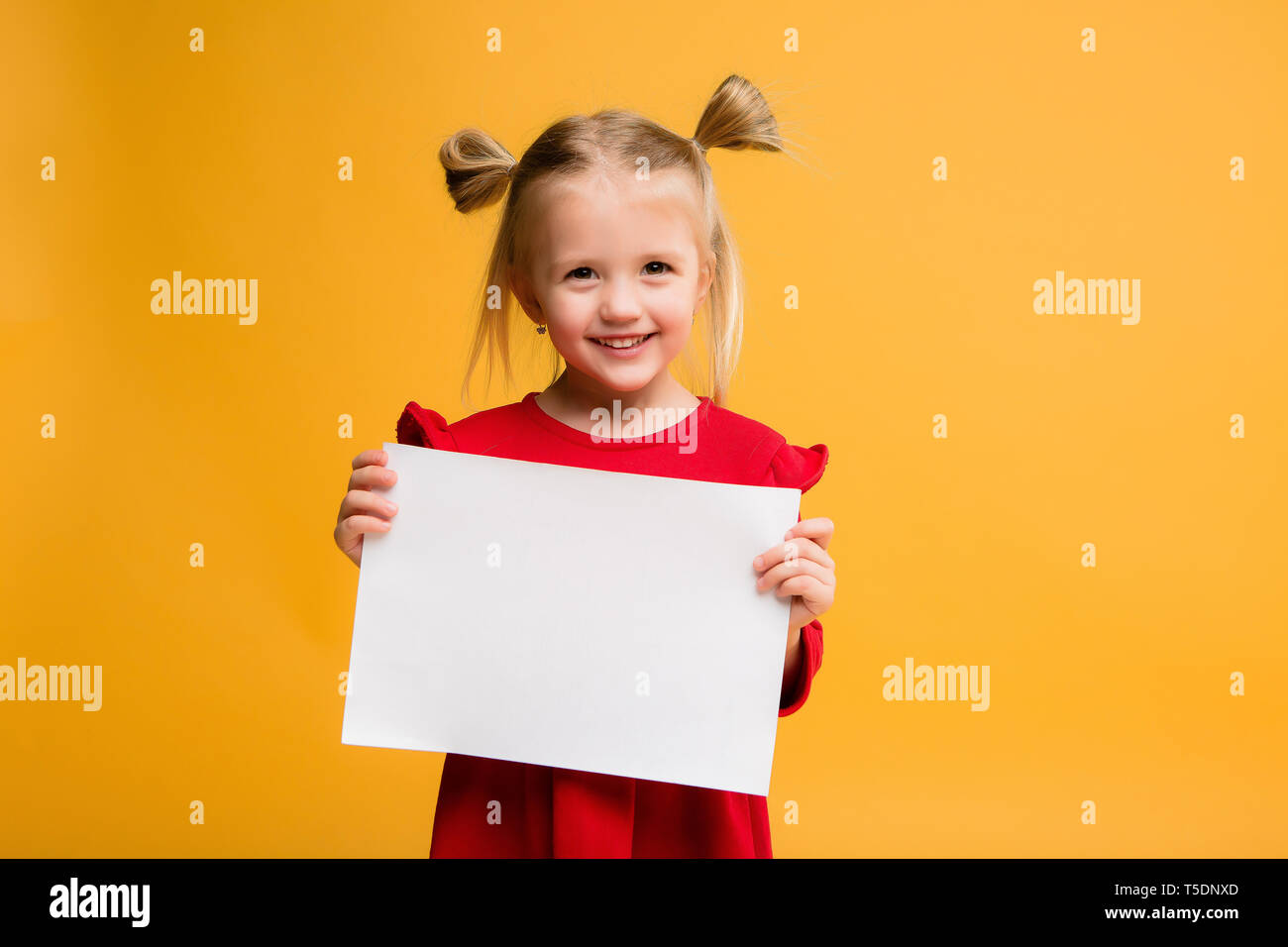 baby girl holding white sheet.Cute little girl with white sheet of ...