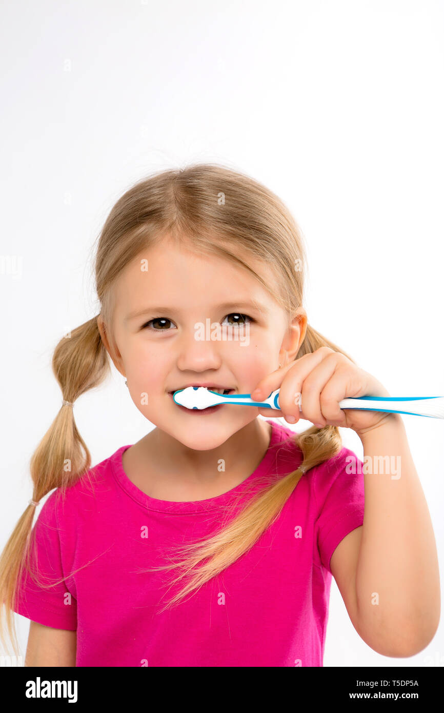 Happy little girl standing with toothbrush isolated on white.little ...