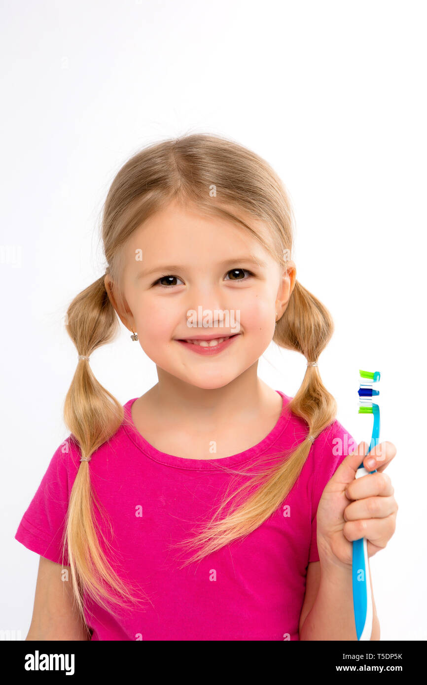 Happy little girl standing with toothbrush isolated on white.little ...